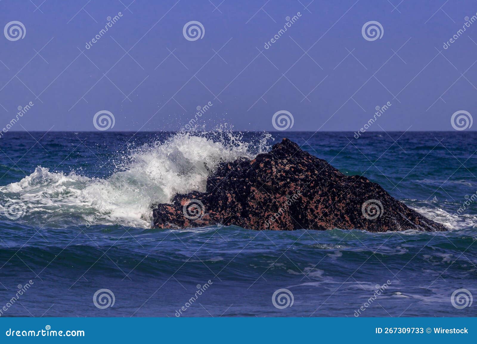 Waves Splashing Against a Boulder in the Sea Stock Image - Image of ...