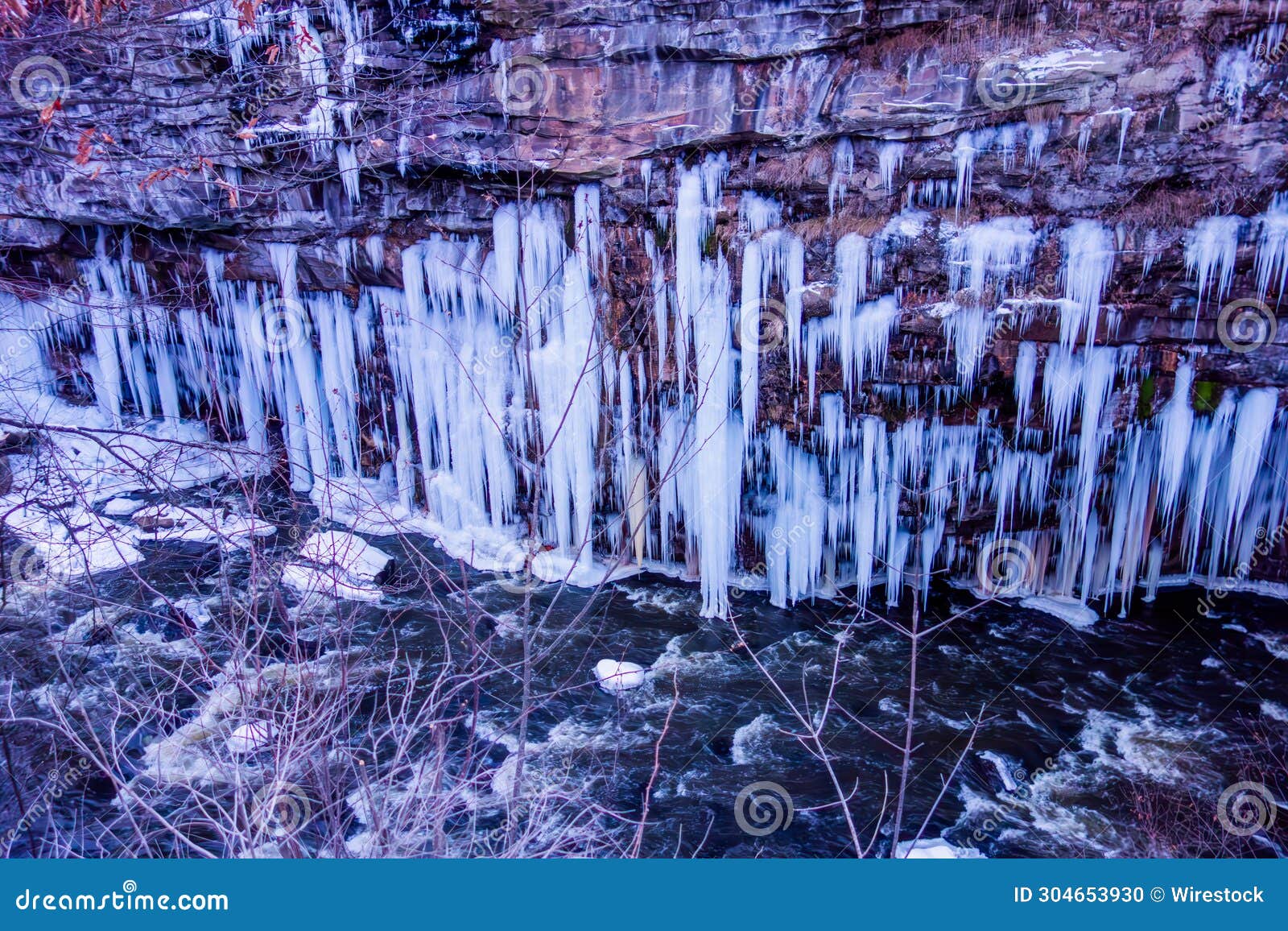 Beautiful Winter Scene Featuring a Cliff Adorned with Sharp Icicles ...