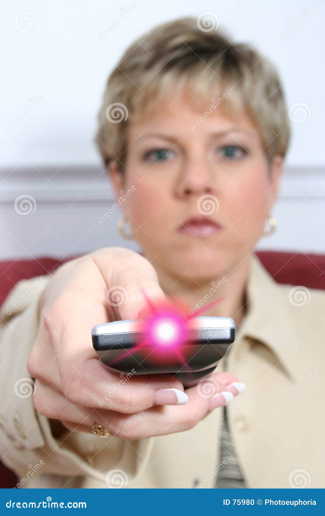 Beautiful Woman Aiming Remote with Light on Stock Photo - Image of ...