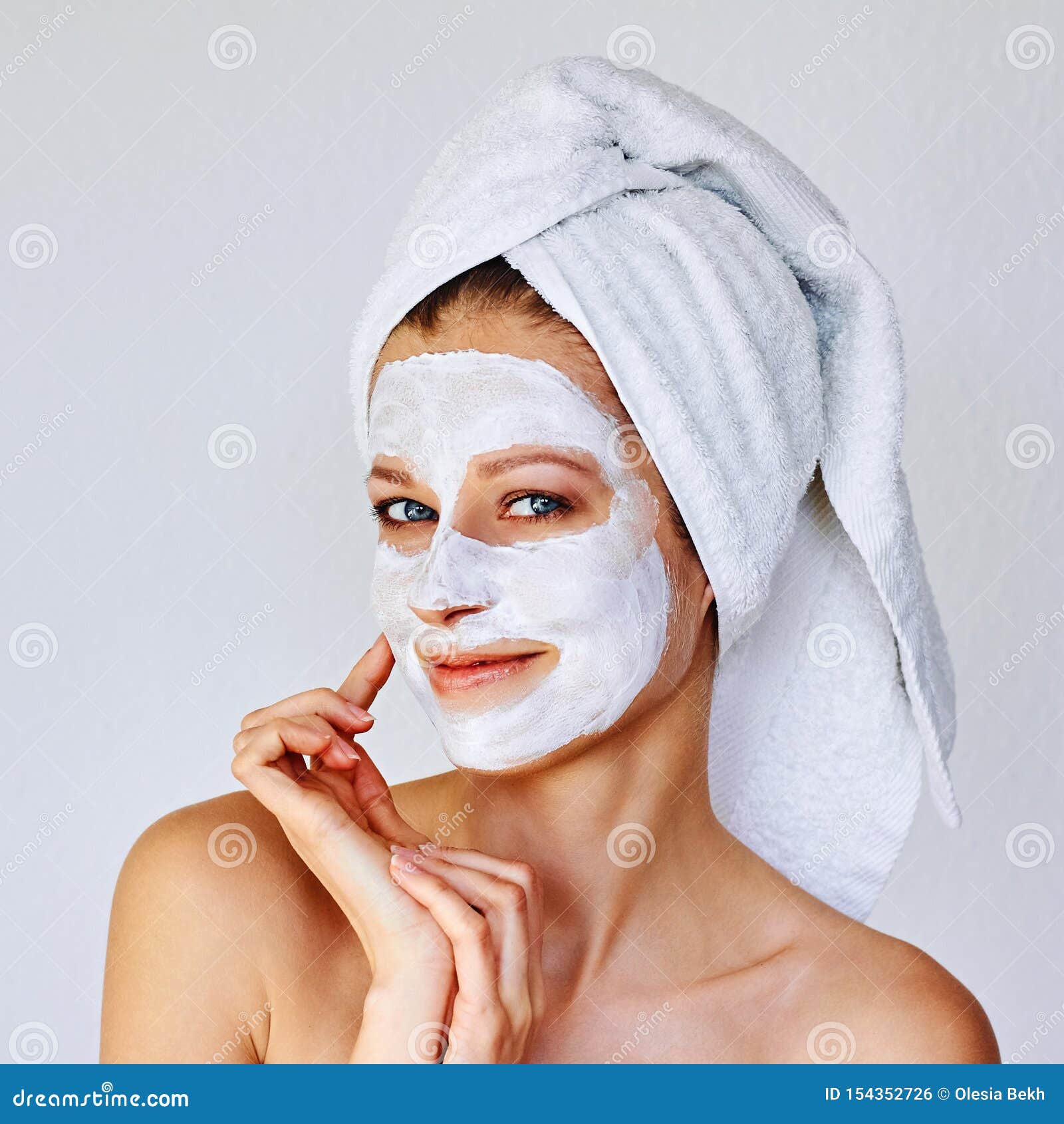 Beautiful Woman Applying Facial Mask On Her Face Skin Care And