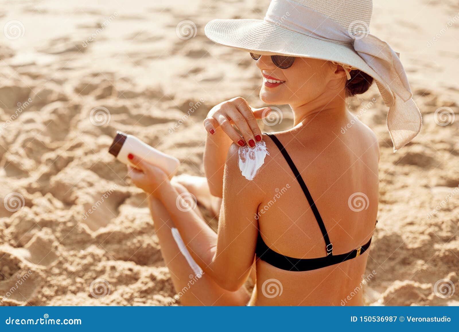 Beautiful Woman In Bikini Applying Sun Cream On Tanned Shoulder Sun
