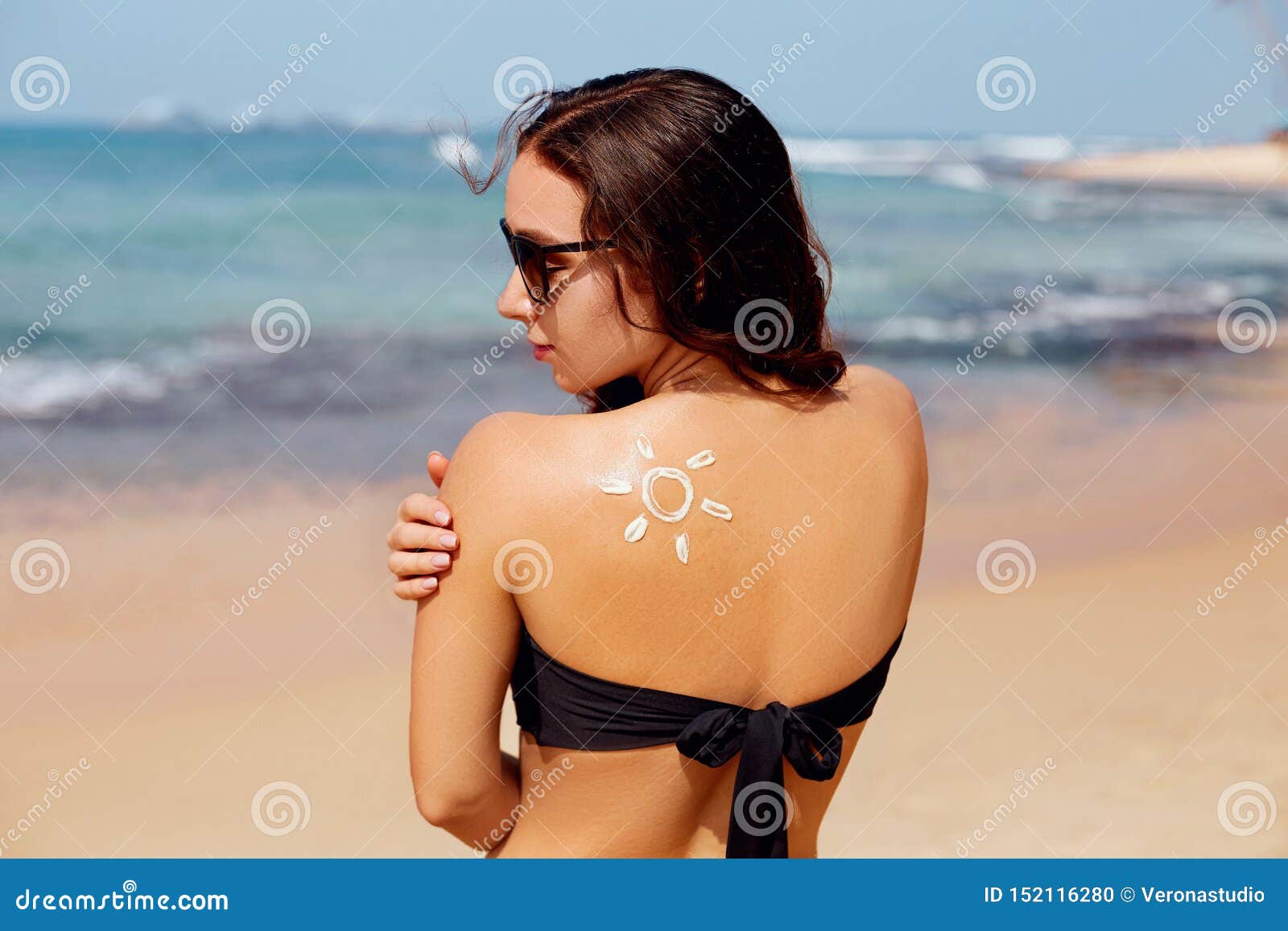 Beautiful Woman In Bikini Applying Sun Cream On Tanned Shoulder Sun