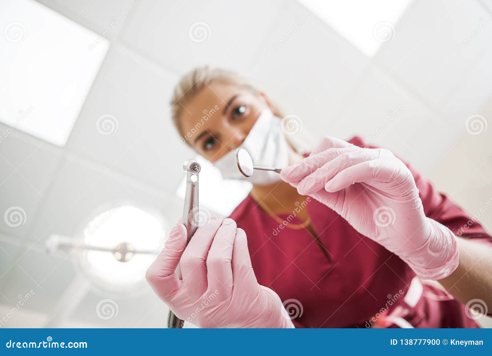 Beautiful Woman Dentist In The Mask With Her Tools Bottom View Stock