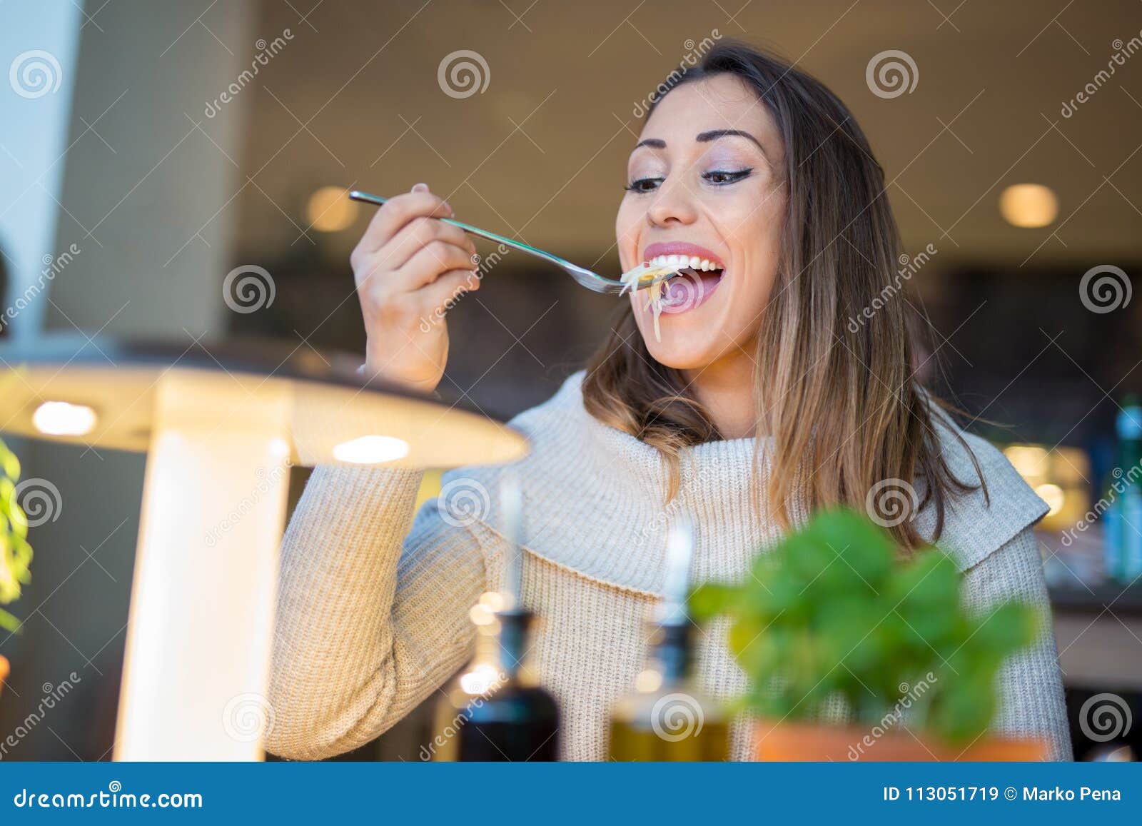 Beautiful Woman Eating Lunch At A Restaurant While Smiling Stock Image