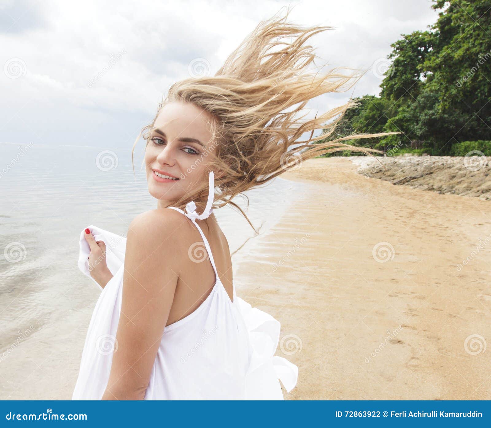 Beautiful Woman Enjoying Summer On The Beach And Wind Blow Her H Stock