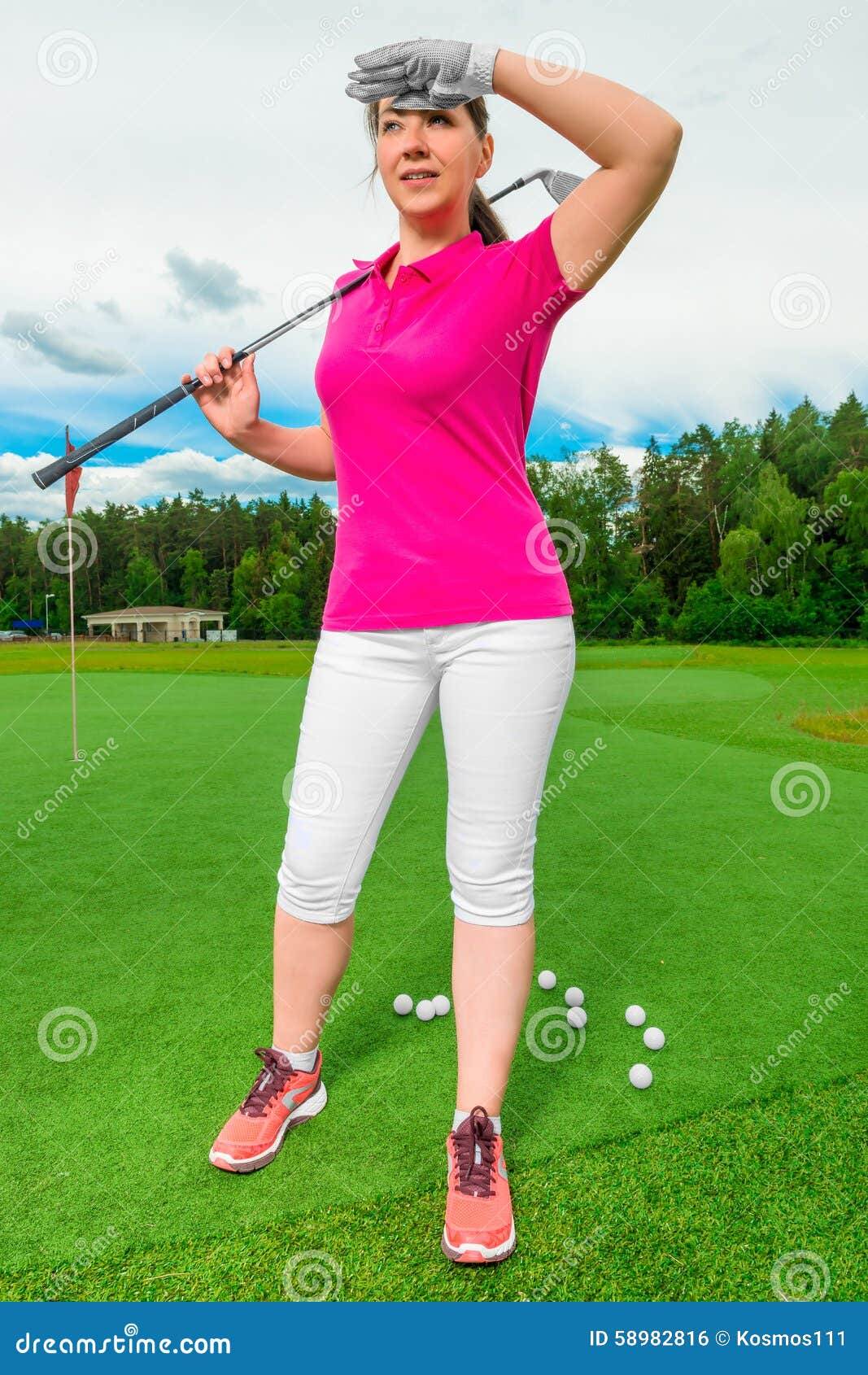 Beautiful Woman on Golf Course Looking Behind Flying Ball Stock Photo ...