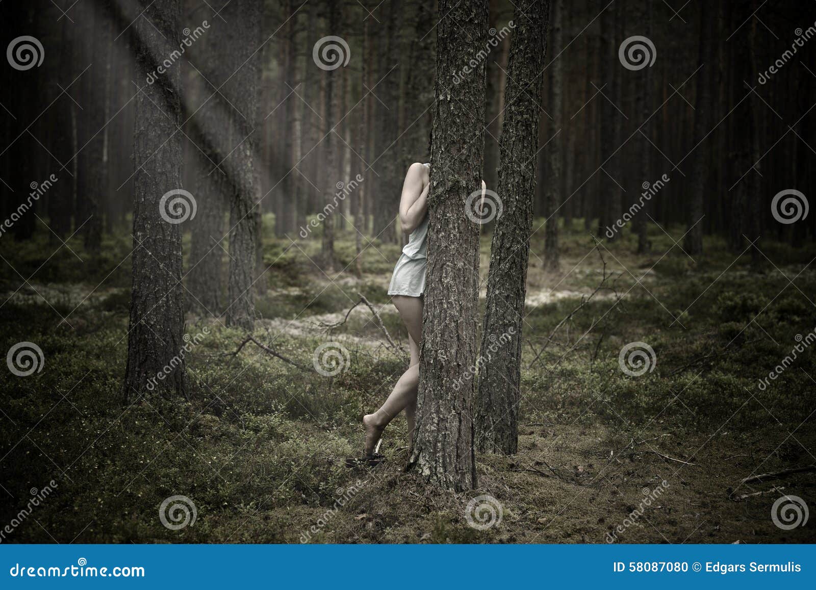 Beautiful Woman Hiding Behind a Tree in the Forest Stock Photo - Image ...