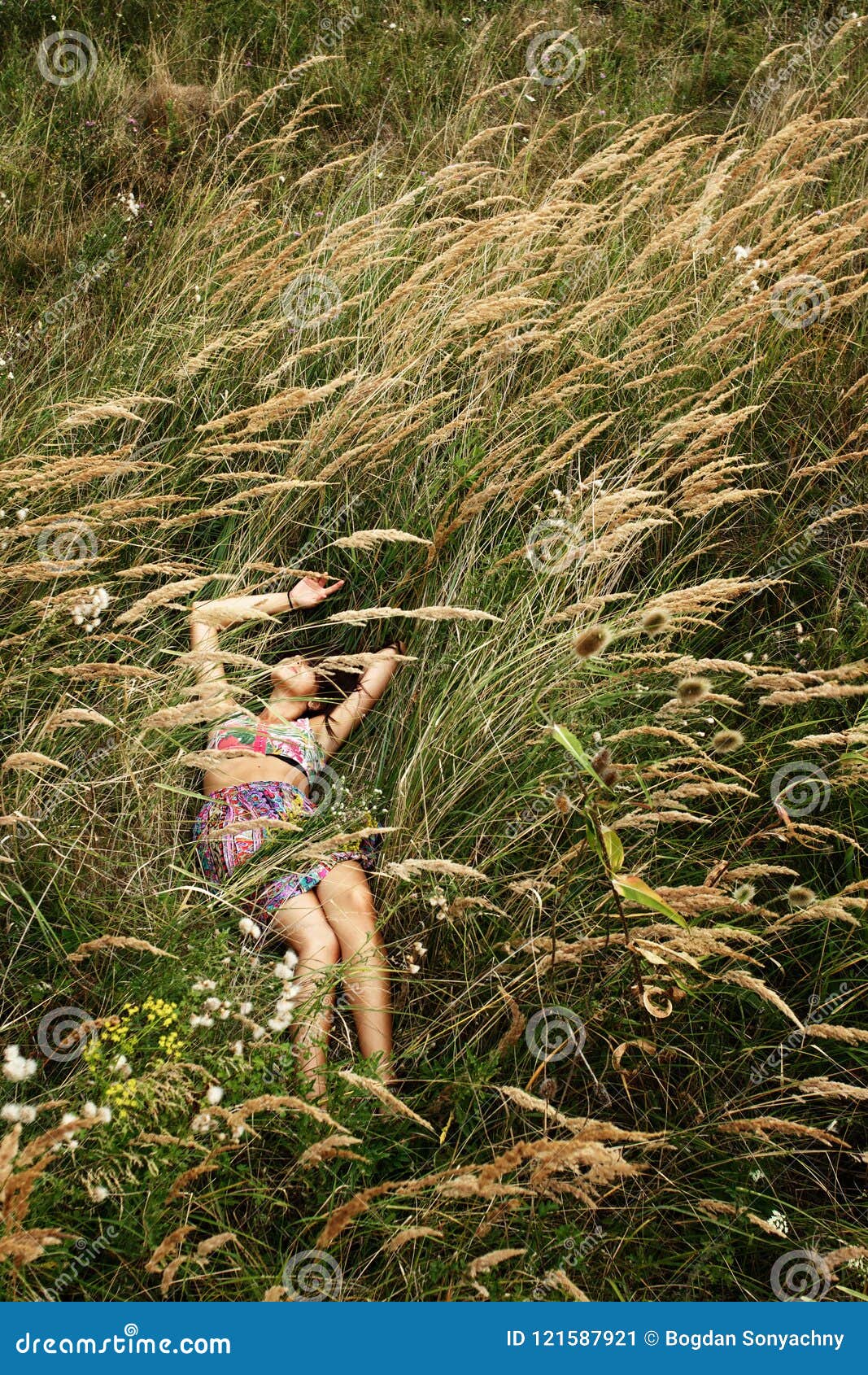 Beautiful Woman Hipster Lying In Grass In Summer Meadow And Relaxing
