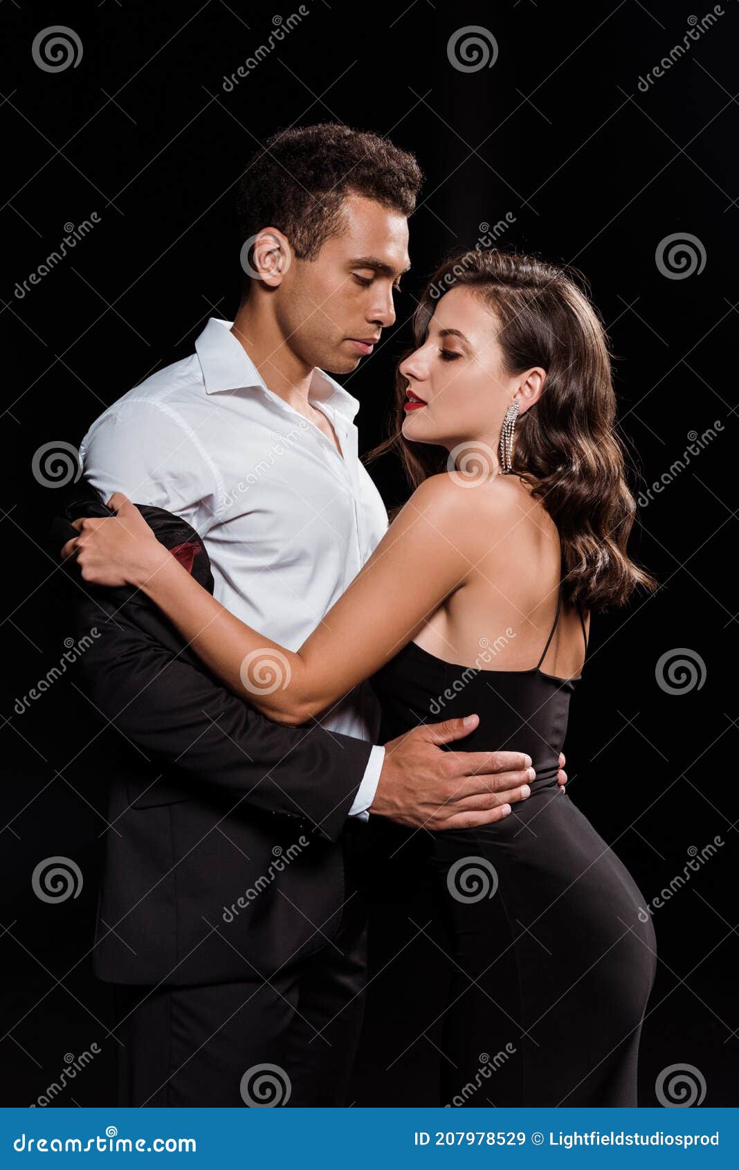 Beautiful Woman Hugging Handsome Bi Racial Man Isolated On Black Stock