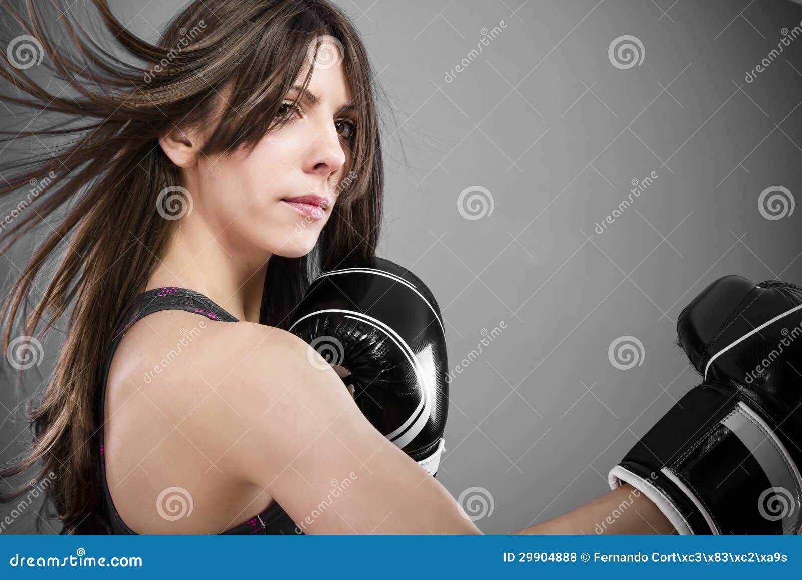 A Young and Fit Female Fighter Posing in Combat Poses Stock Photo ...