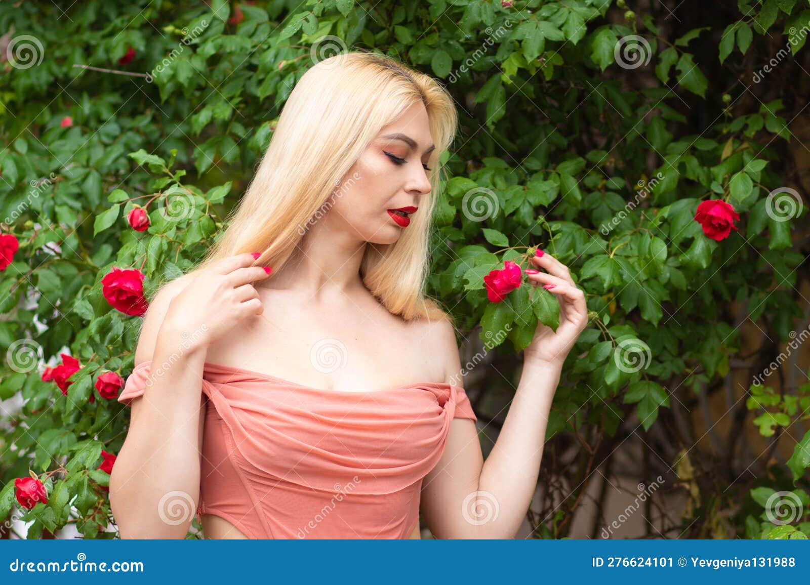 Beautiful Woman With Long Blonde Hair And Red Lips Wearing Pink Clothes