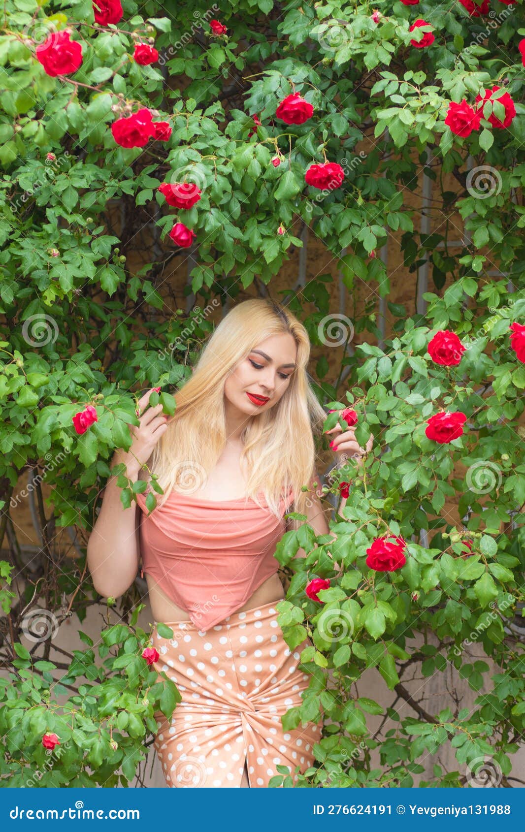 Beautiful Woman With Long Blonde Hair And Red Lips Wearing Pink Clothes