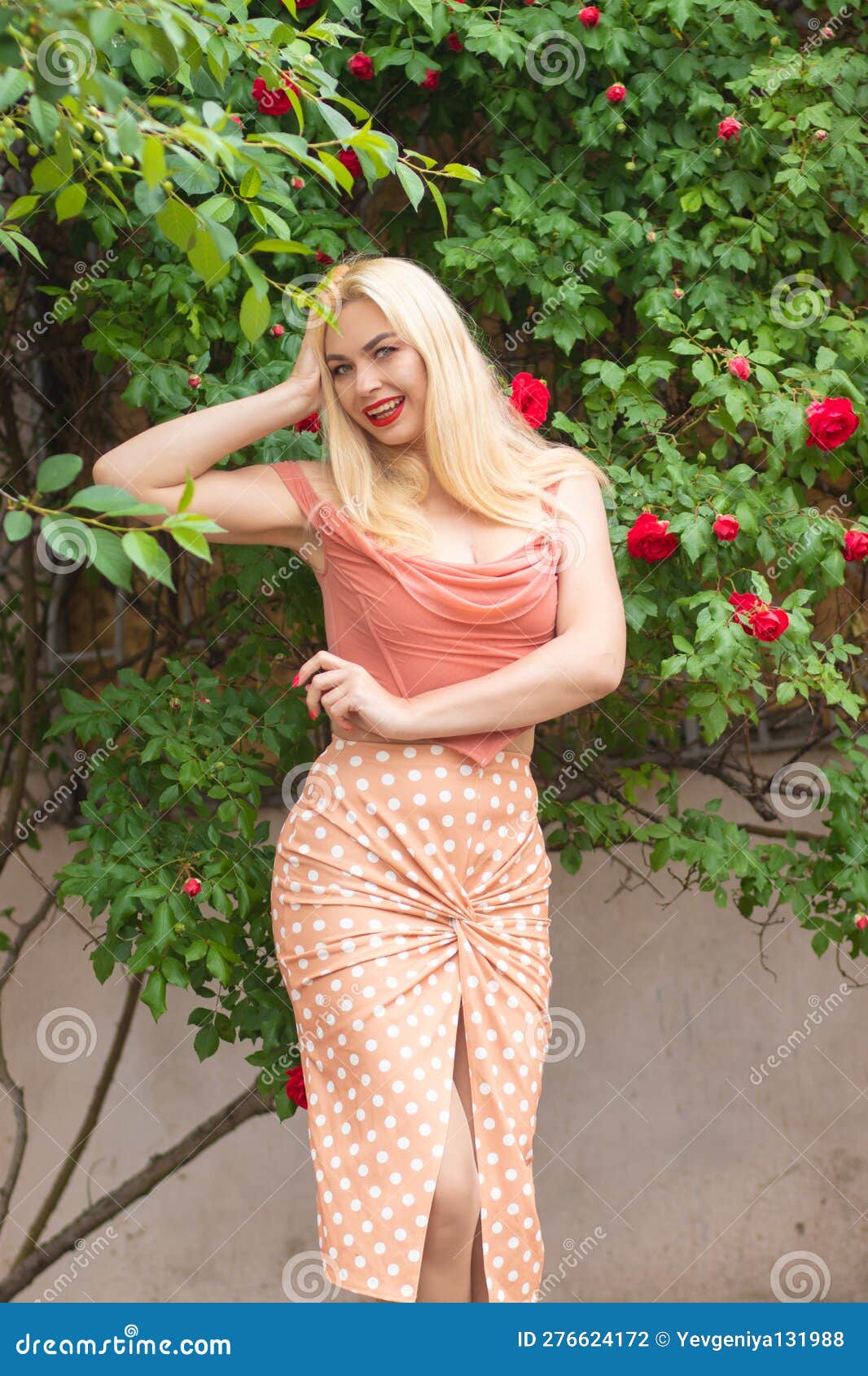 Beautiful Woman With Long Blonde Hair And Red Lips Wearing Pink Clothes