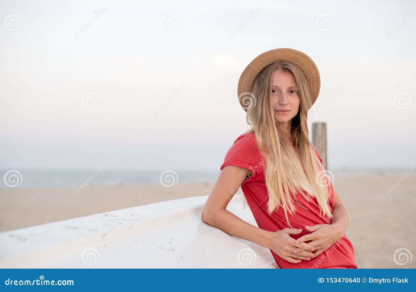 Beautiful Woman With Long Hair Wear Straw Hat On The Beach Near Wooden