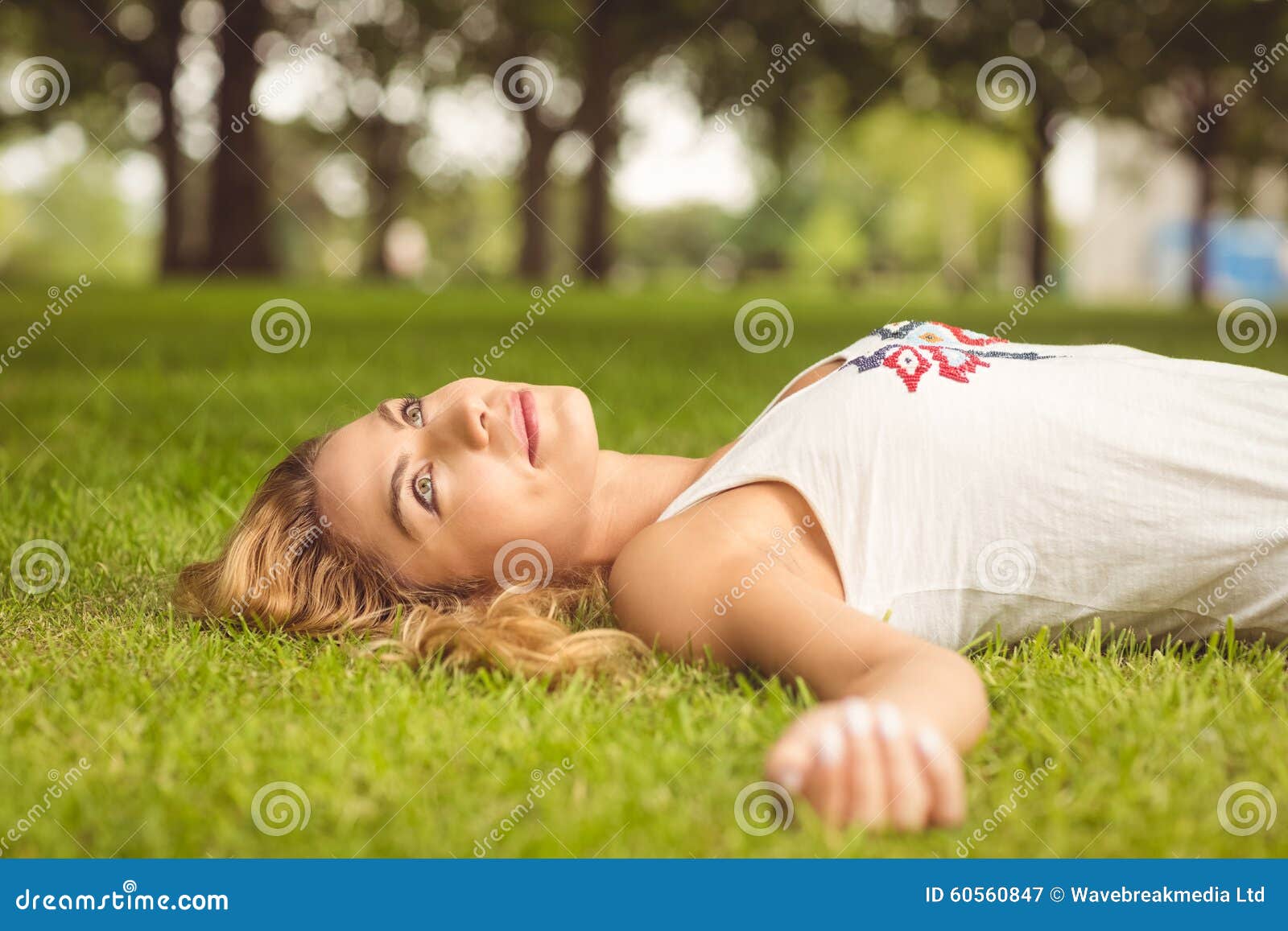 Beautiful Woman Looking Up while Lying on Grass Stock Image - Image of ...