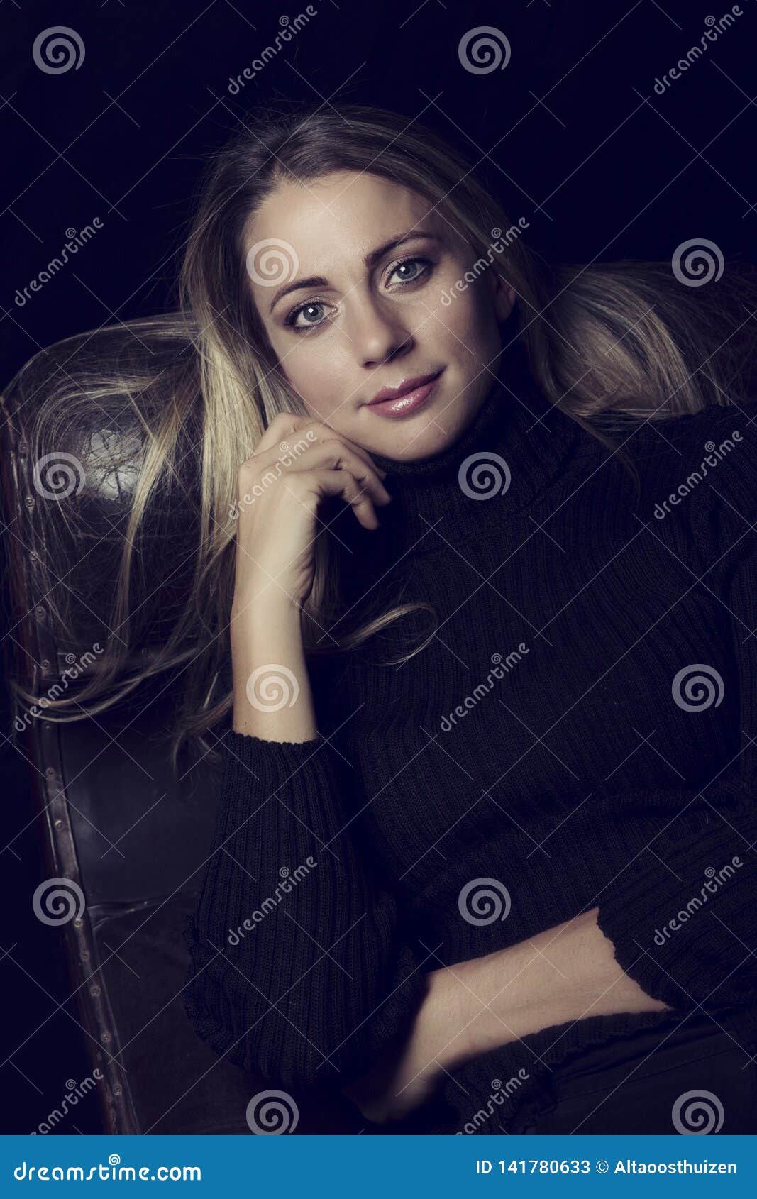Beautiful Woman In Low Light Sitting On A Leather Sofa Artistic
