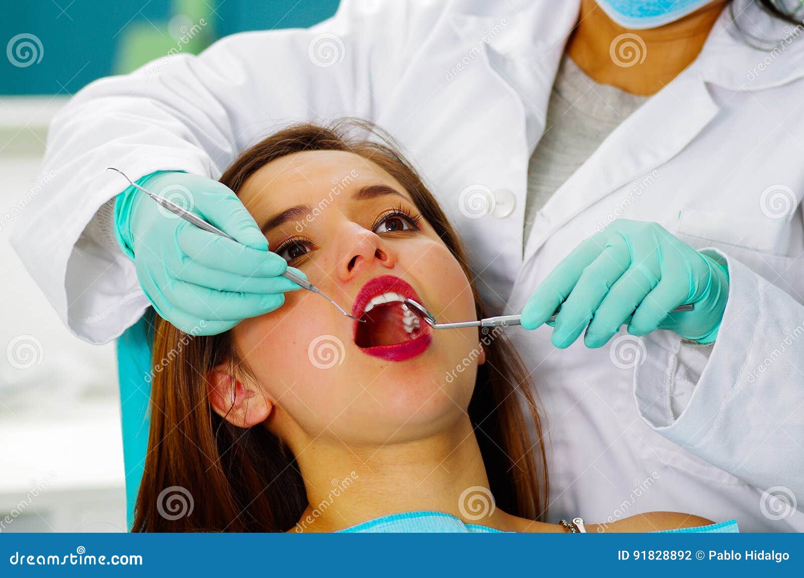 Beautiful Woman Patient Having Dental Treatment At Dentist`s Office