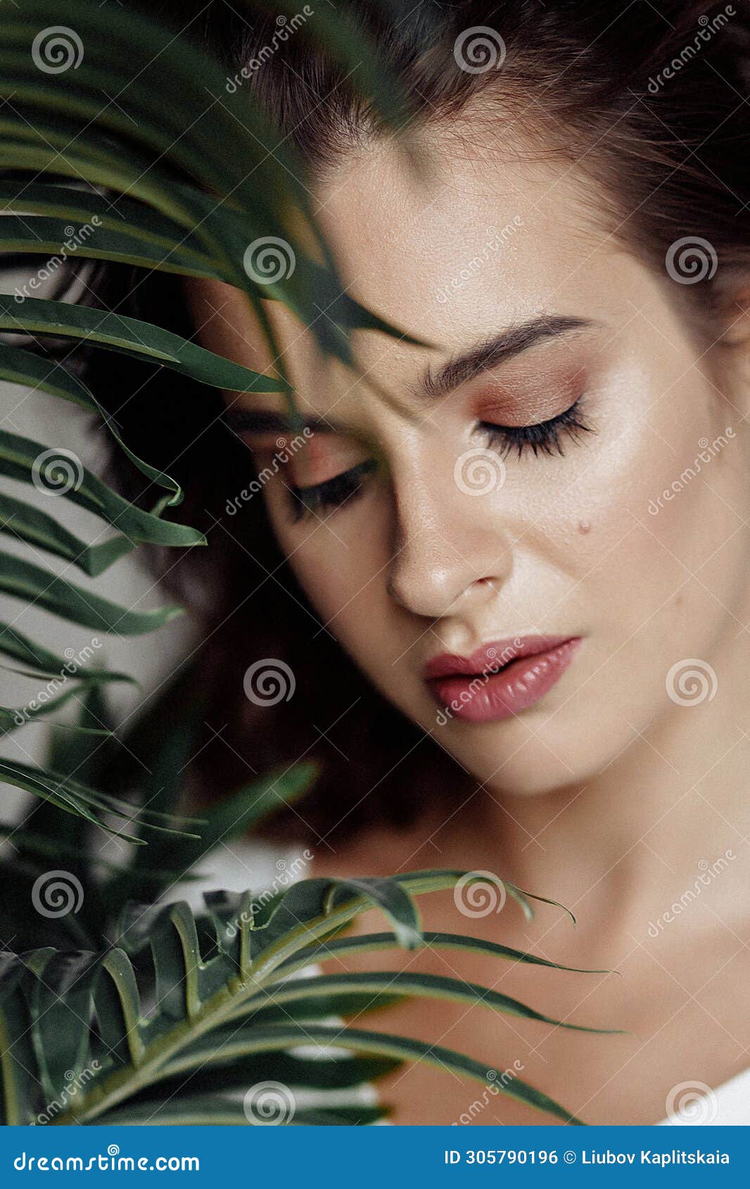 Beautiful Woman With Perfect Skin And Natural Make Up Holding Tropical