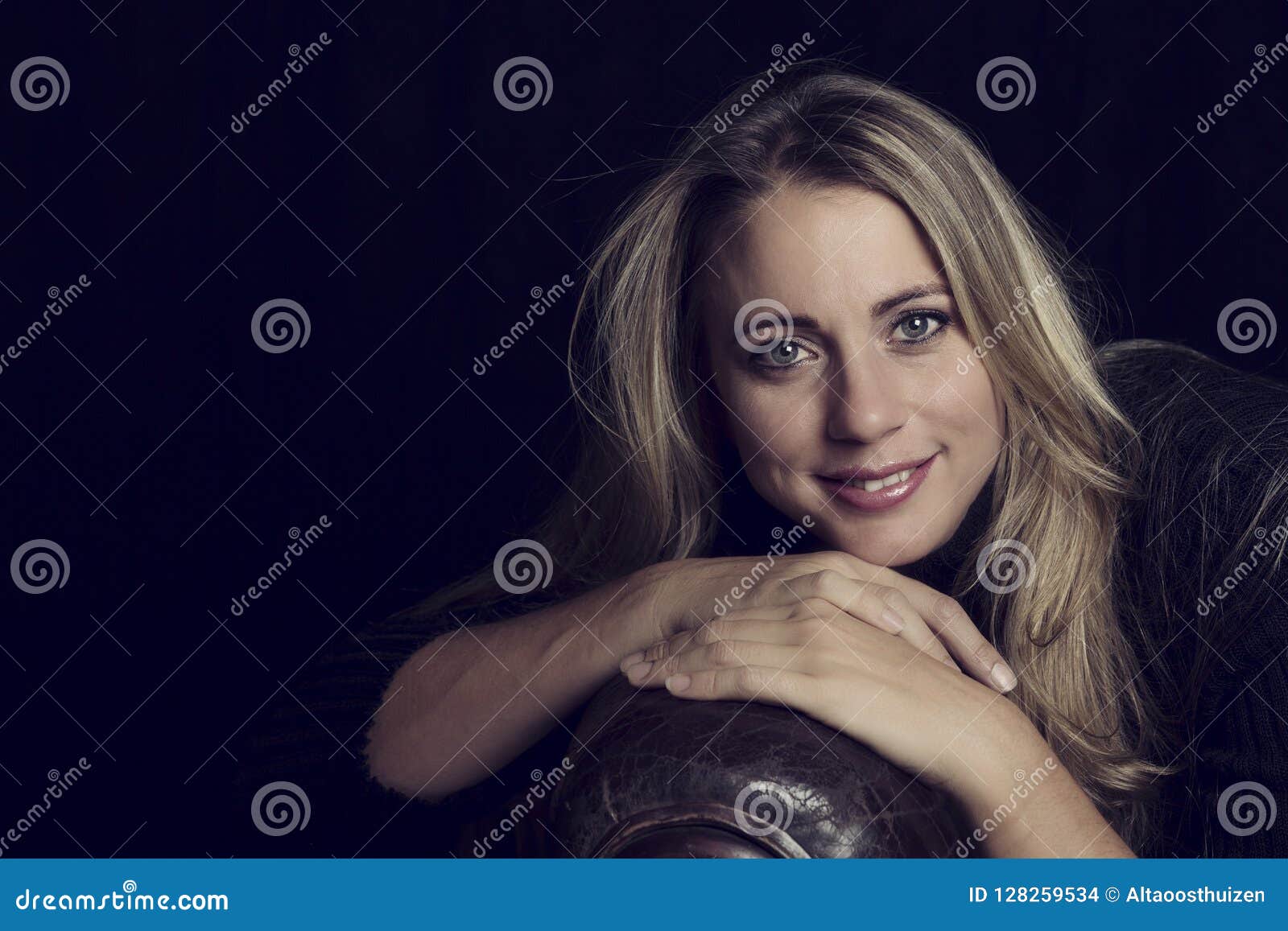 Beautiful Woman Portrait In Low Light Sitting On Brown Leather S Stock