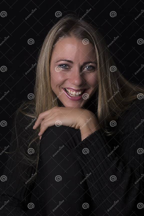 Beautiful Woman Portrait In Low Light Sitting On Brown Leather Sofa