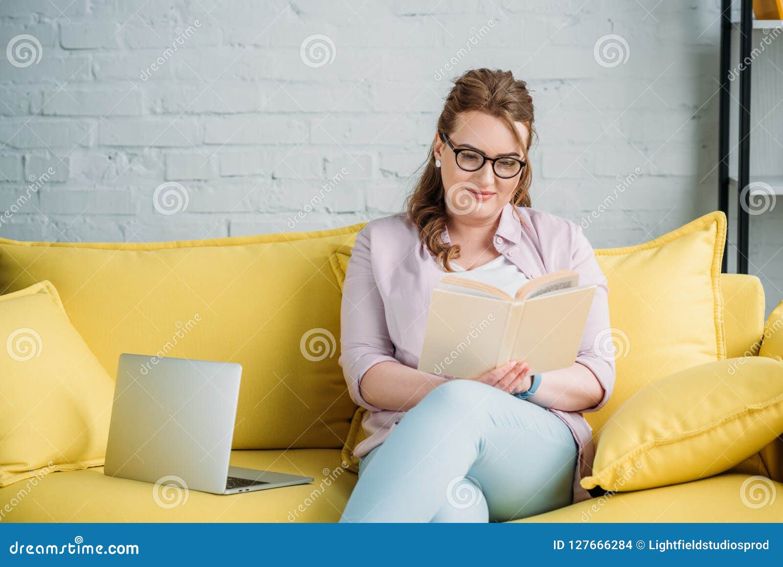Beautiful Woman Reading Book and Studying on Sofa Stock Photo - Image ...