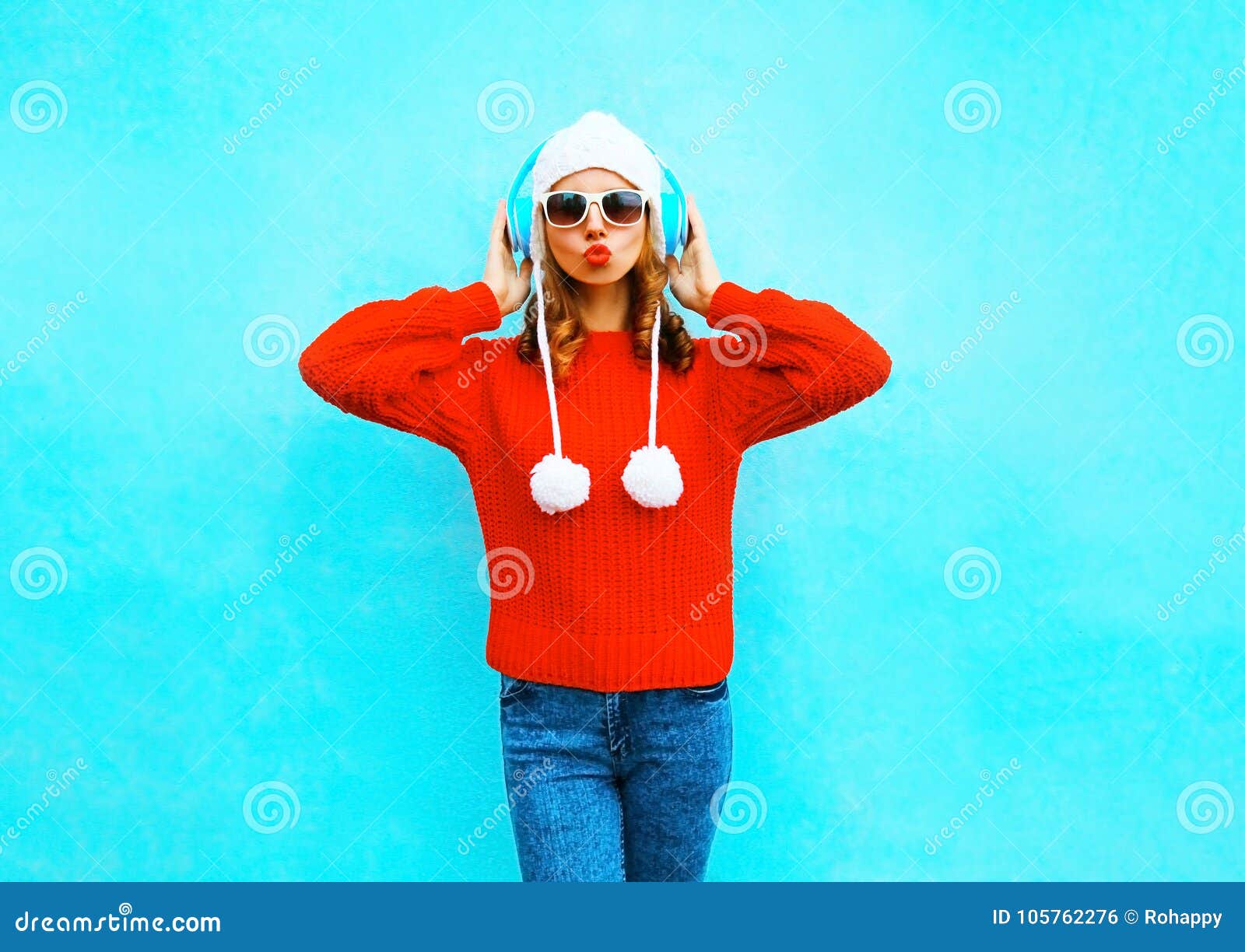 Beautiful Woman In Red Sweater Listens To Music In Wireless Headphones
