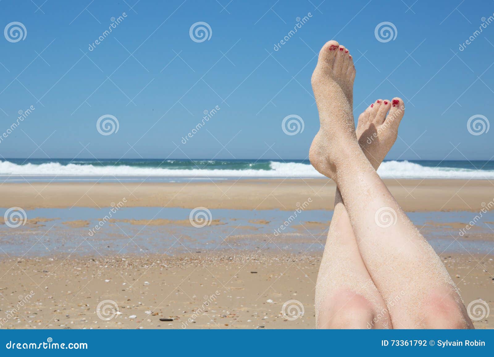 Beautiful Woman S Legs on the Beach Stock Photo - Image of foot, lying ...