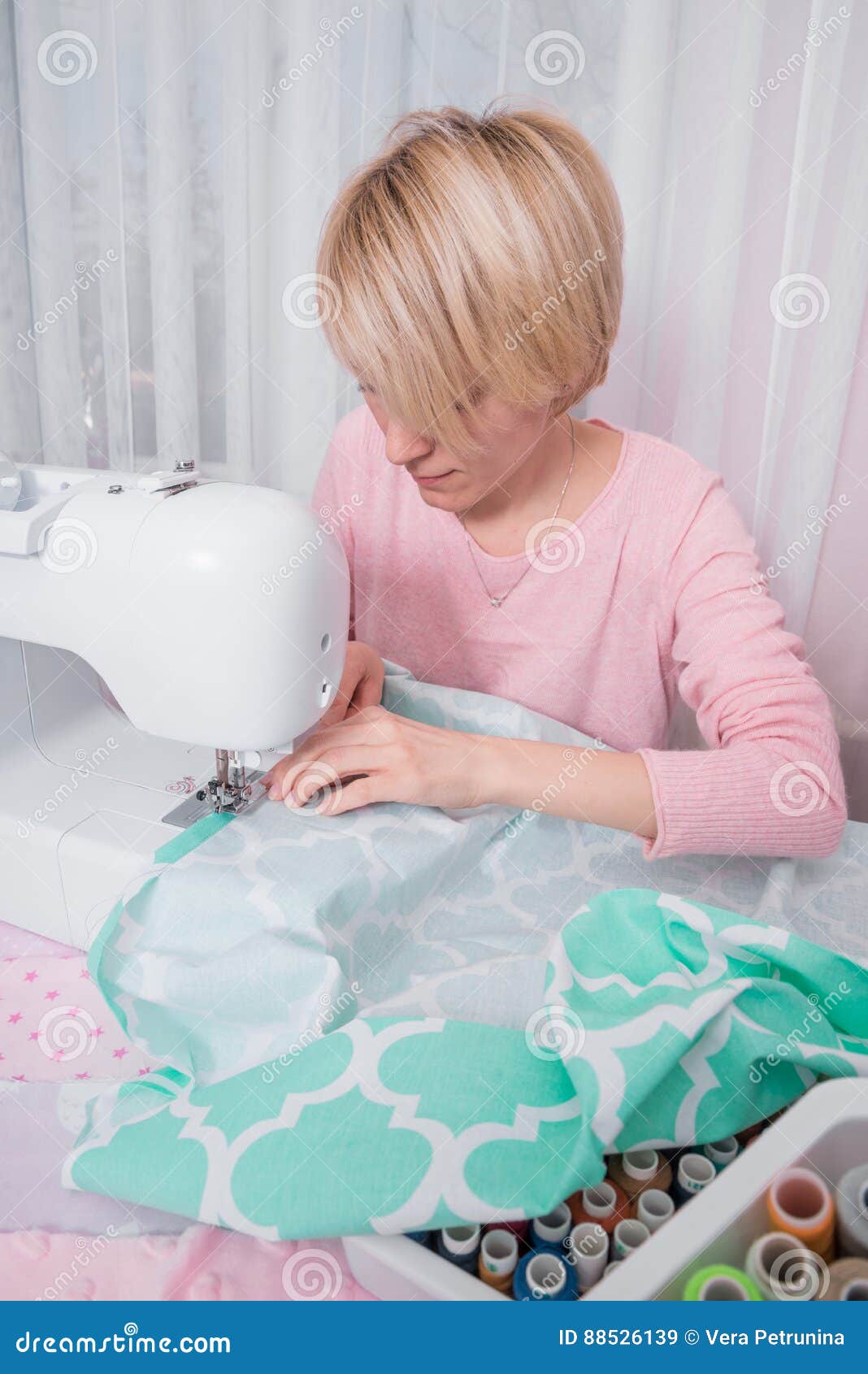 Beautiful Woman Seamstress Sew On The Sewing Machine Clothes Stock