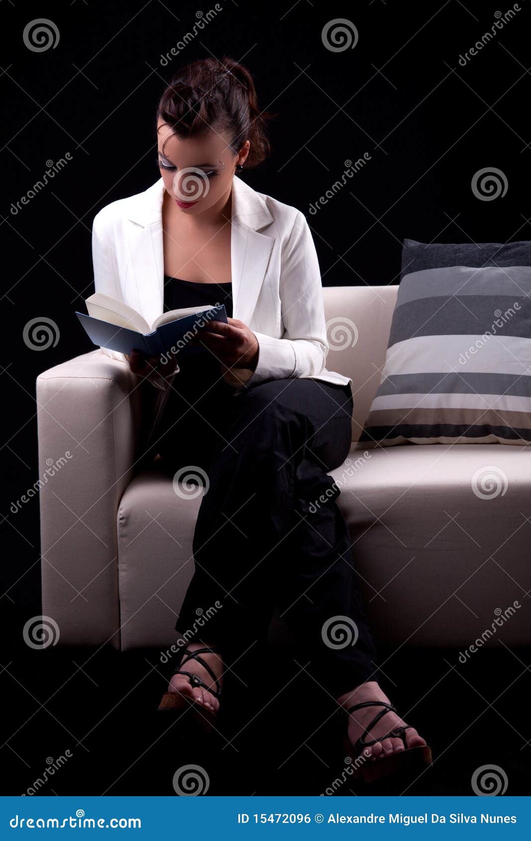 Beautiful Woman Seated on Couch Reading a Book Stock Photo - Image of ...