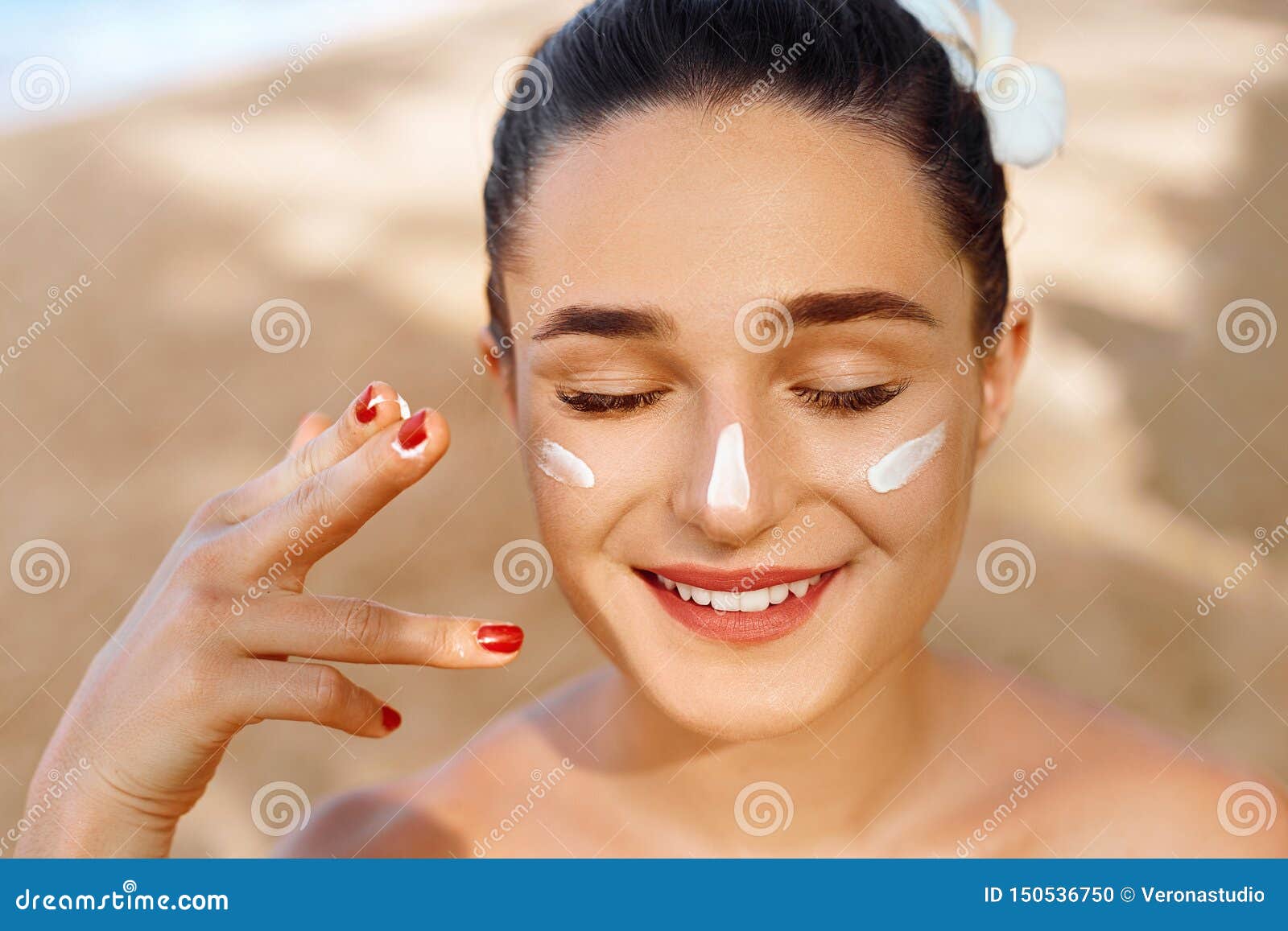 Beautiful Woman Smile Applying Sun Cream On Face Skin And Body Care