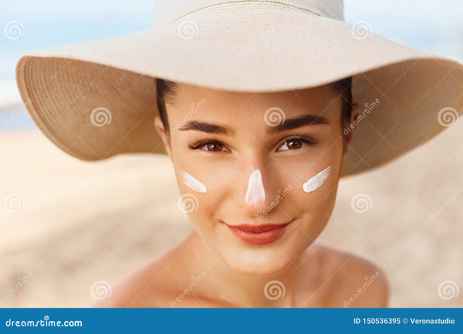 Beautiful Woman Smile Applying Sun Cream On Face Skin And Body Care