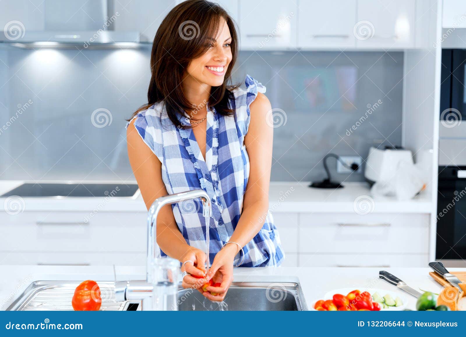 Beautiful Woman Standing in the Kitchen and Smiling Stock Photo - Image ...