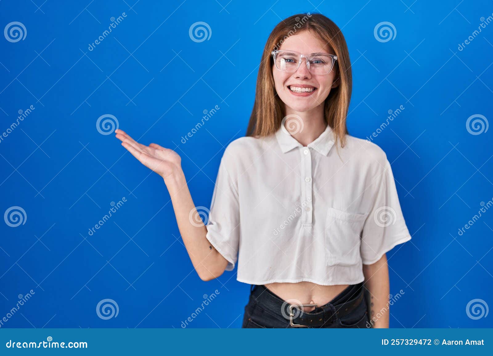 Beautiful Woman Standing Over Blue Background Smiling Cheerful