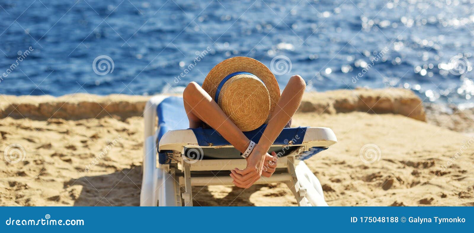 Beautiful Woman Sunbathing On A Beach At Tropical Travel Resort