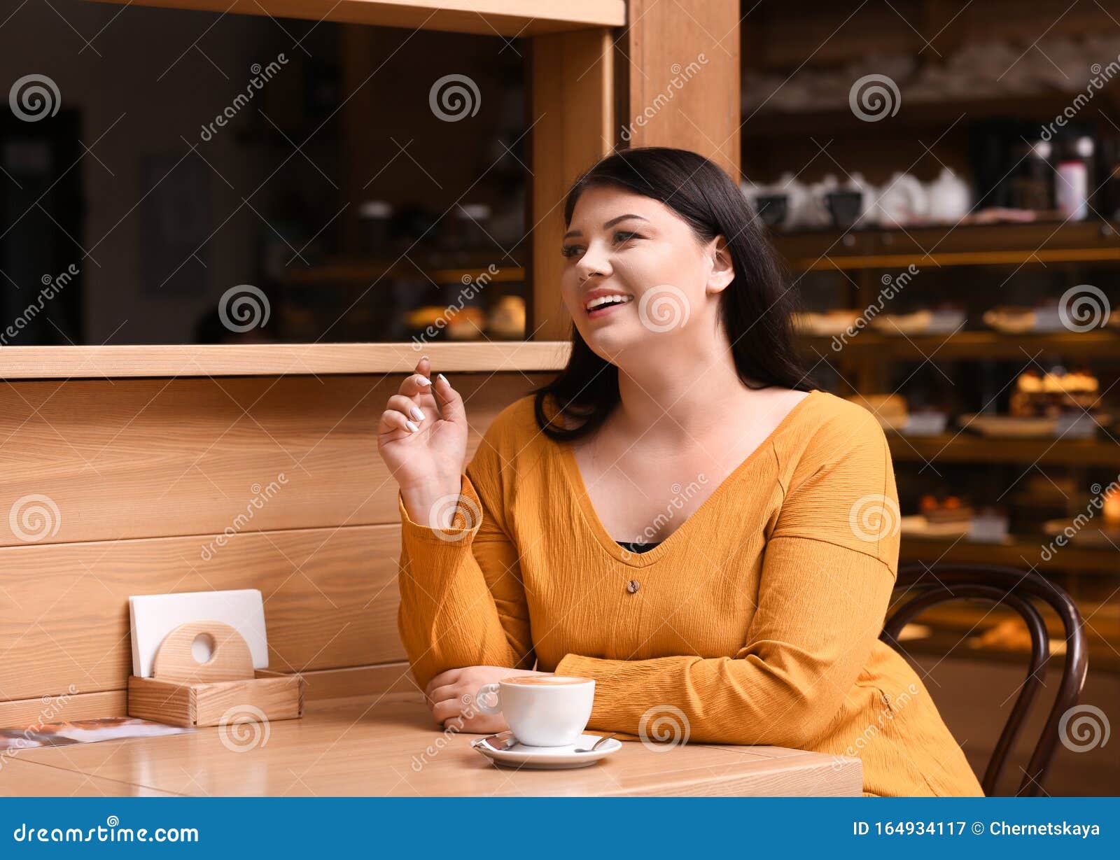 Beautiful Woman at Table in Cafe. Plus Size Model Stock Image - Image ...