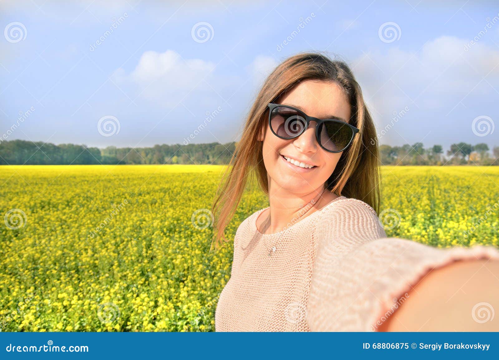 Beautiful Woman Taking Selfie Picture Of Herself In Yellow Field With