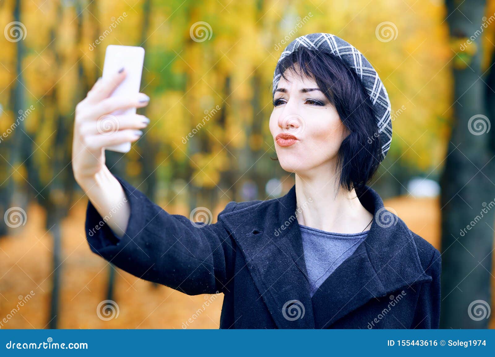 Beautiful Woman Taking Selfie By Smartphone And Having Fun In Autumn