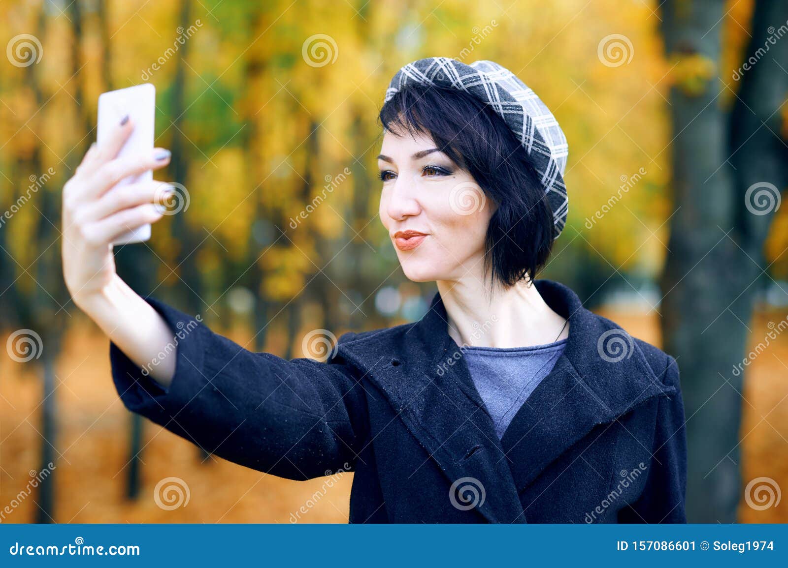 Beautiful Woman Taking Selfie By Smartphone And Having Fun In Autumn