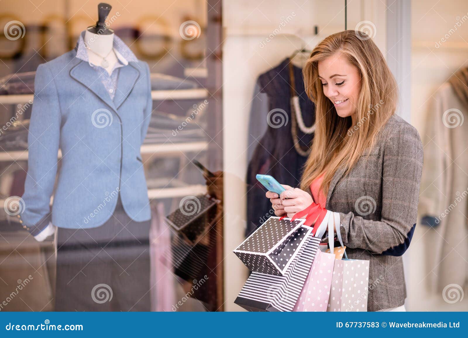 Beautiful Woman Using Her Phone while Window Shopping Stock Image ...