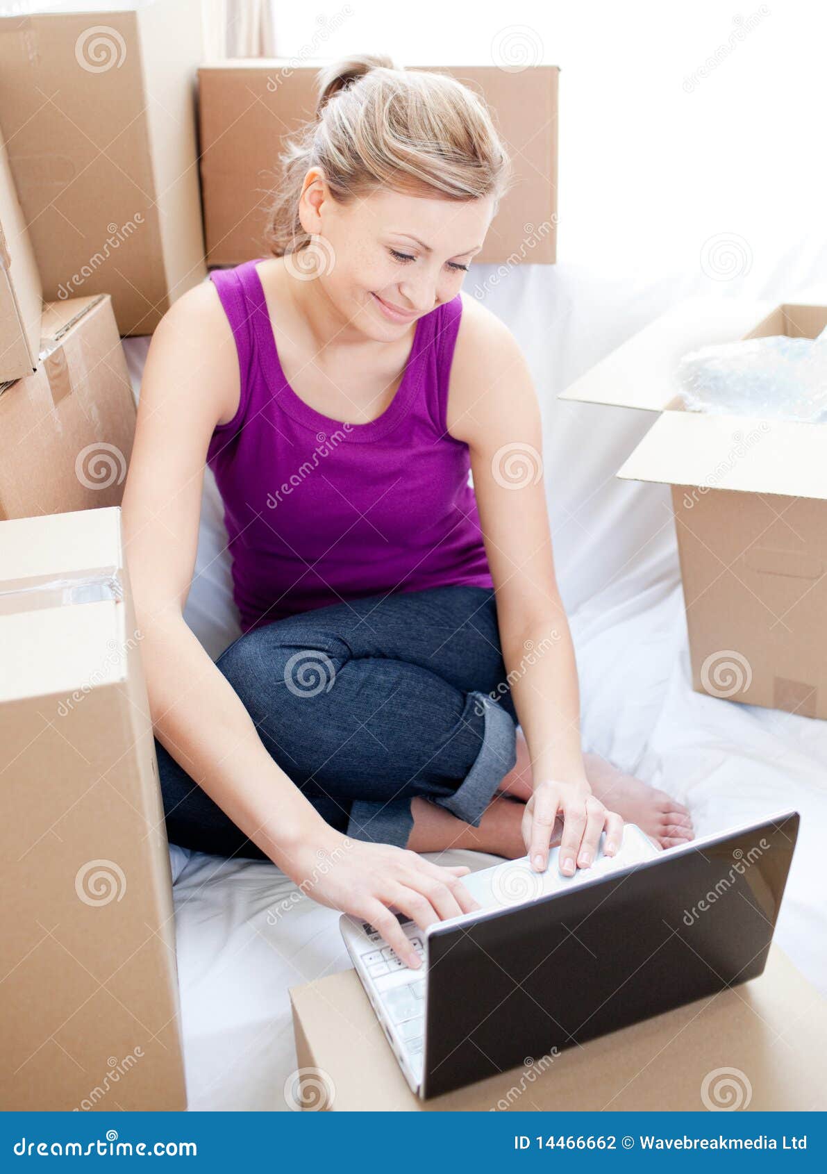 Beautiful Woman Using a Laptop while Unpacking Box Stock Photo - Image ...
