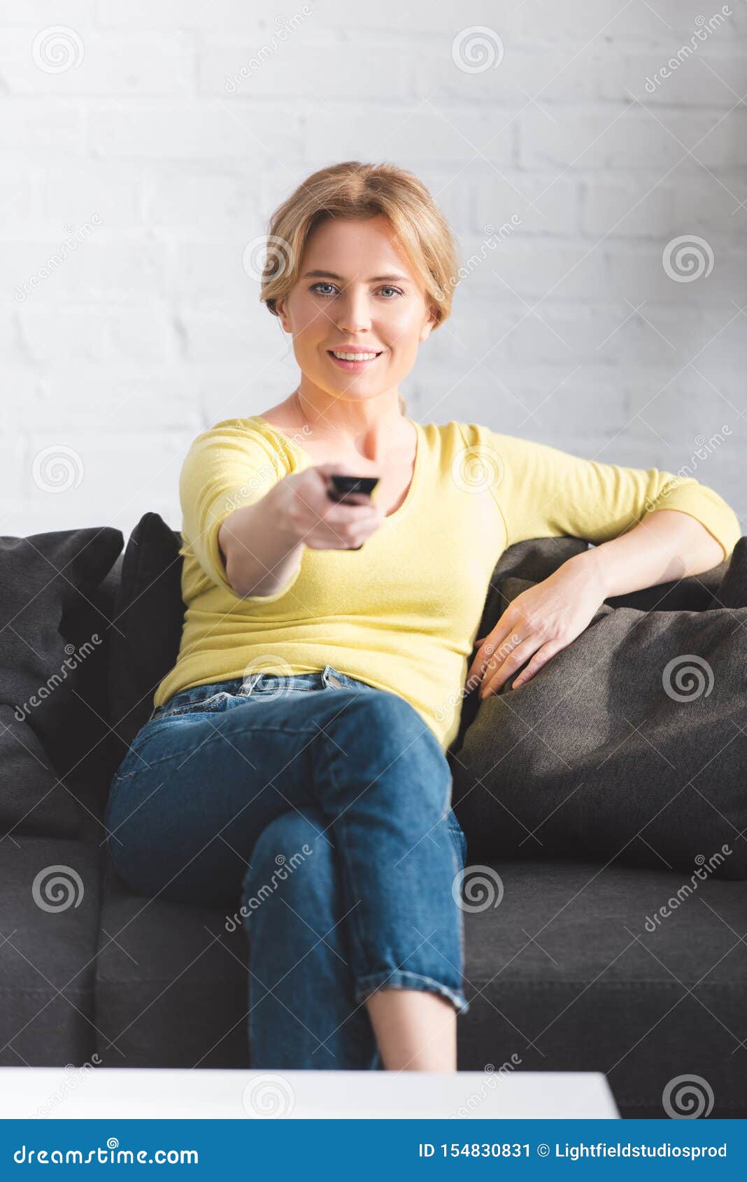 Beautiful Woman Using Remote Controller and Smiling Stock Image - Image ...