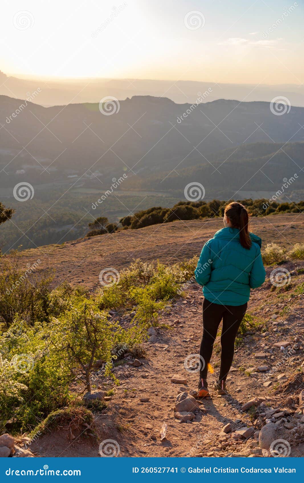 Beautiful Woman Walking on a Path during Sunset with Mountains on the ...