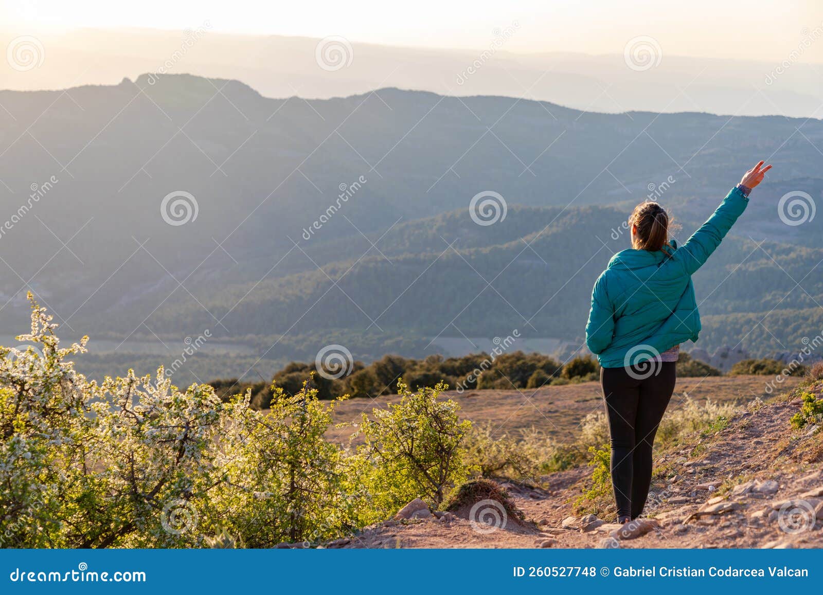 Beautiful Woman Walking on a Path during Sunset One Hand Up Stock Photo ...