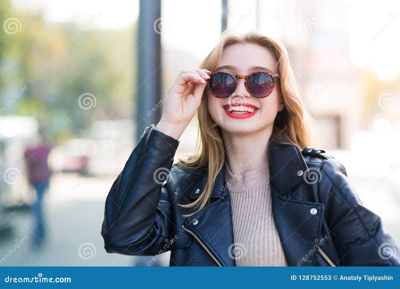 Beautiful Woman Walks Through City Streets Between Building Stock Image