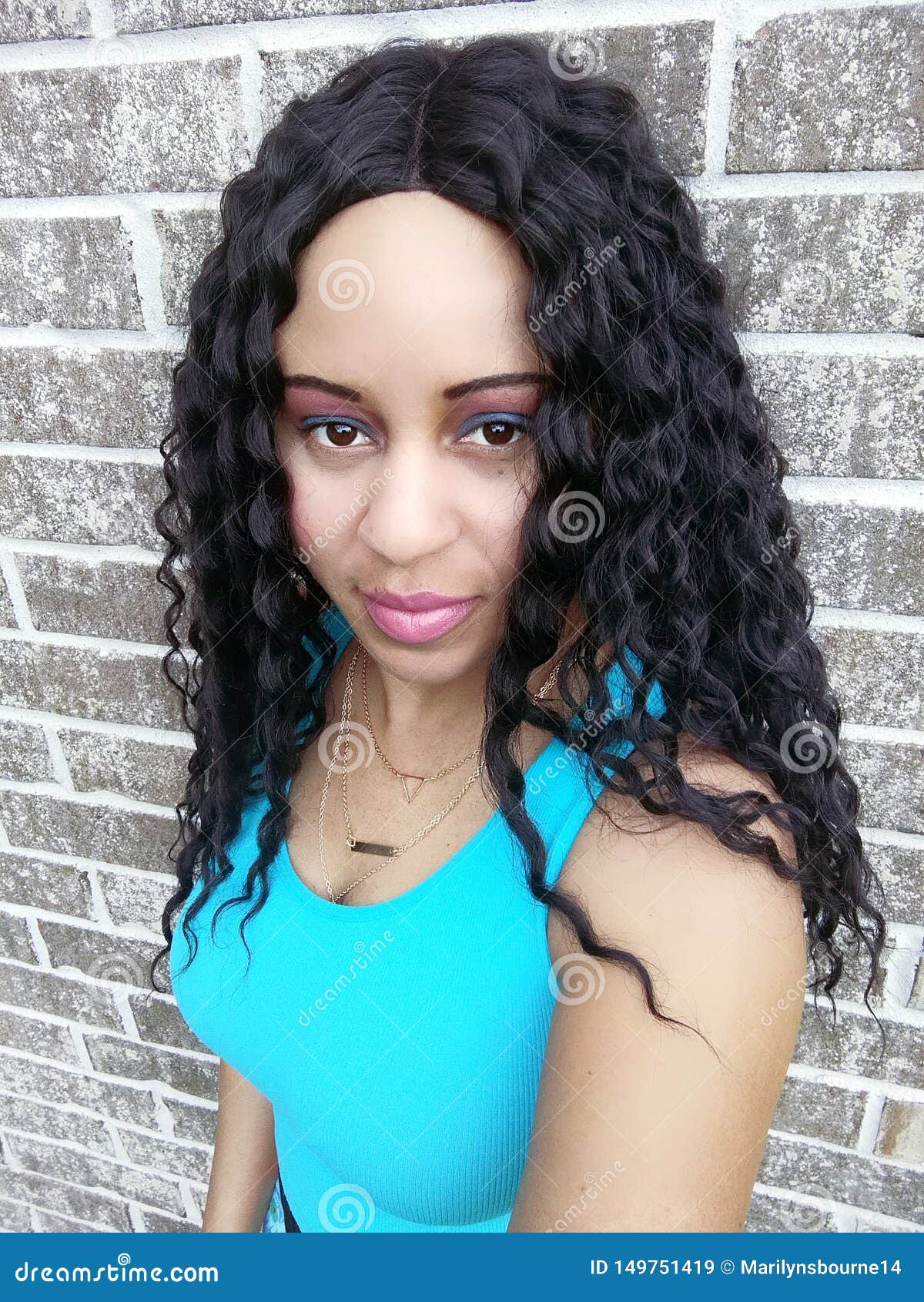 Beautiful Woman In Portrait With Brick Textured Background Stock Image