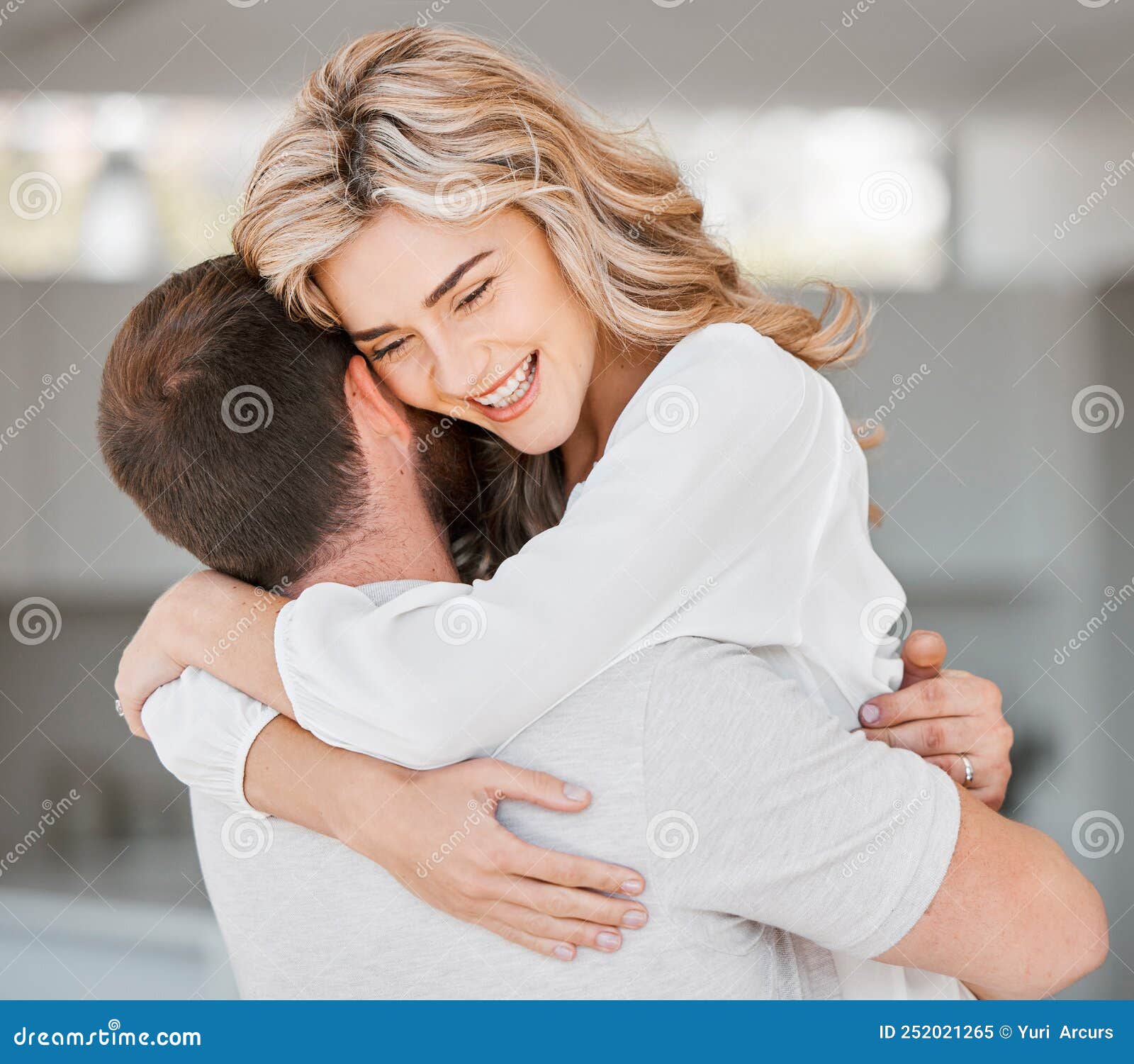 Beautiful Woman Hugging Husband While Smiling In Their Home Young Wife