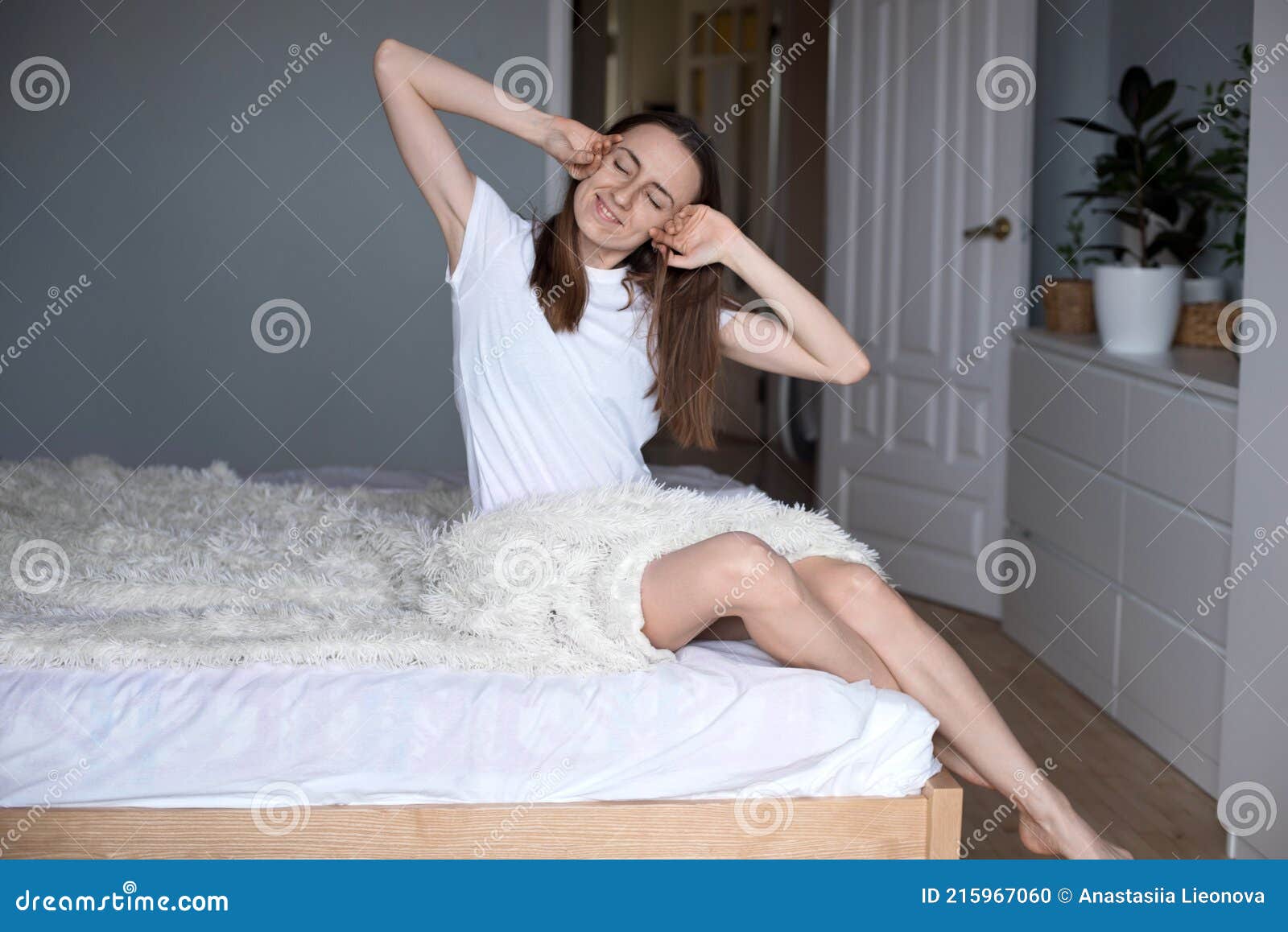 Beautiful Women Slowly Waking Up Stretches And Gets Up From The Bed