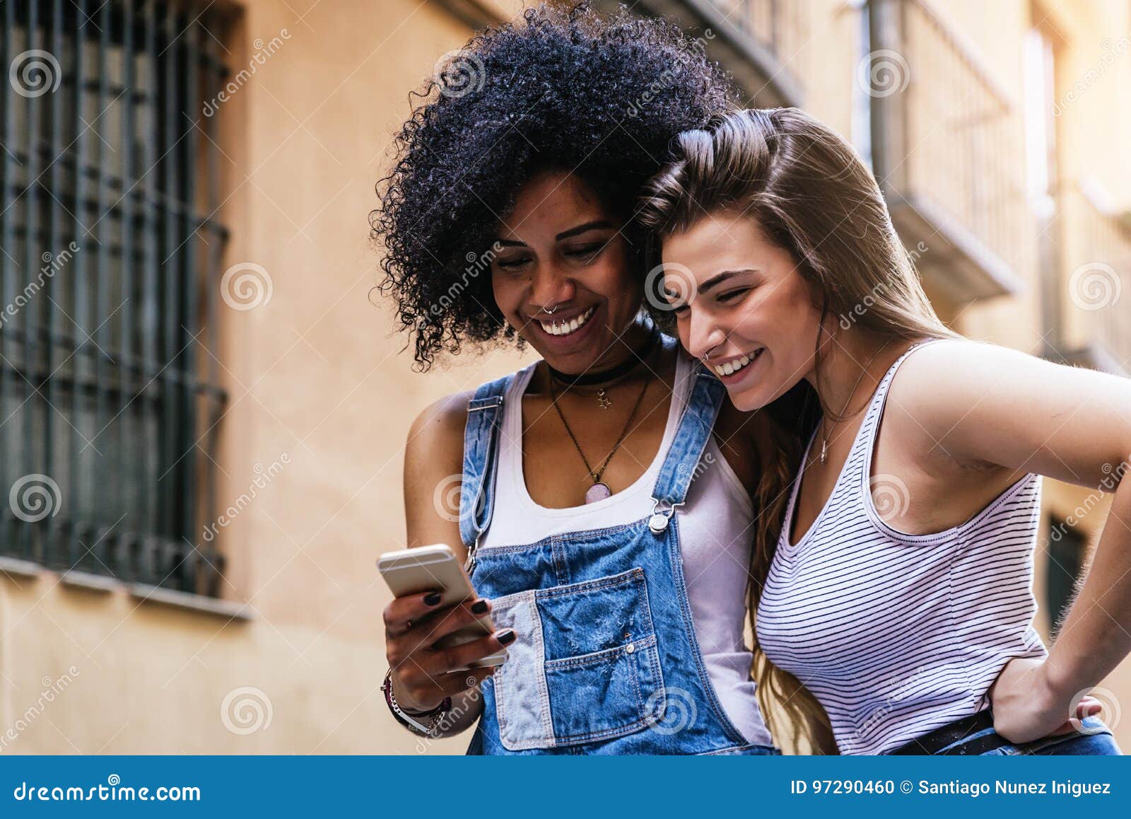 Beautiful Women Using a Mobile in the Street. Stock Photo - Image of ...