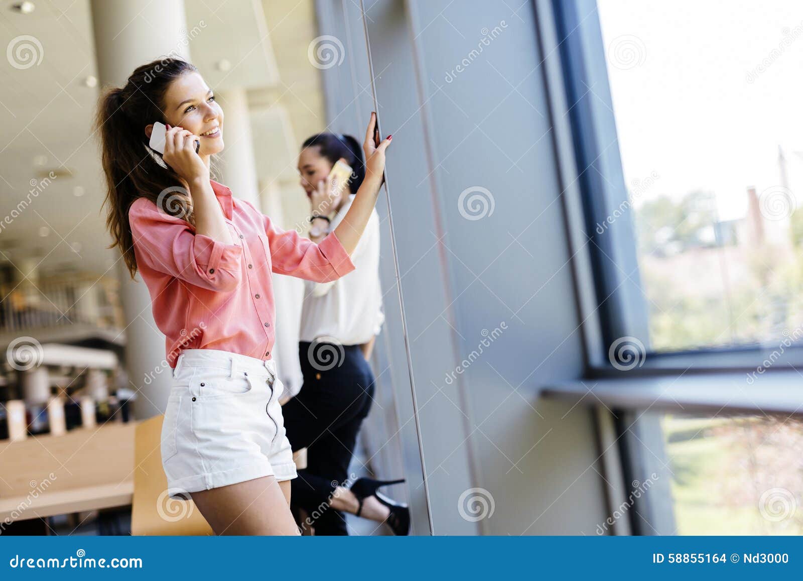 Beautiful Women Using Phones and Talkin during Break Stock Photo ...