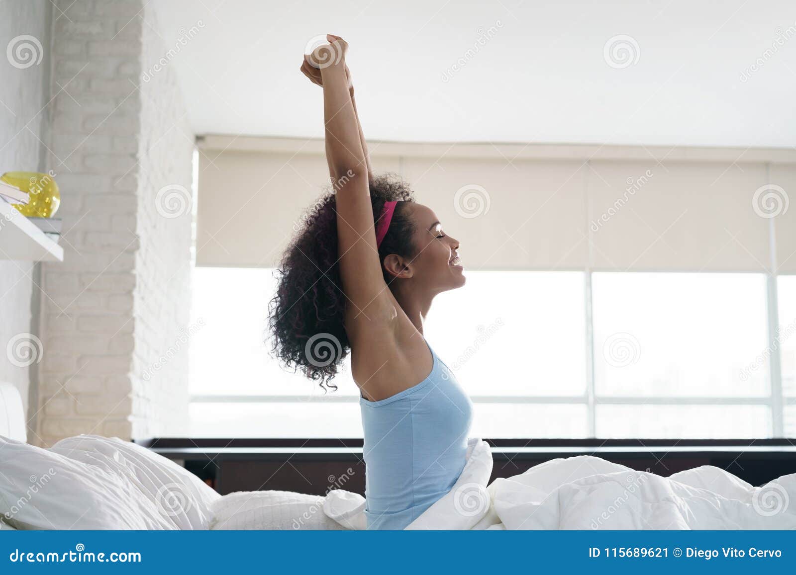 Beautiful Young African American Woman Waking Up In Bed Stock Image